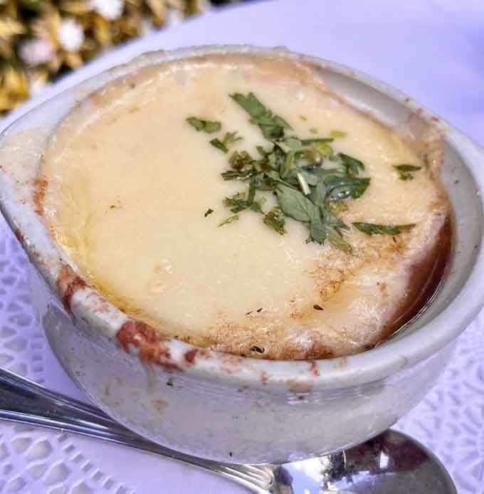 French onion soup with a cheese blanket so generous it deserves its own zip code and property taxes.