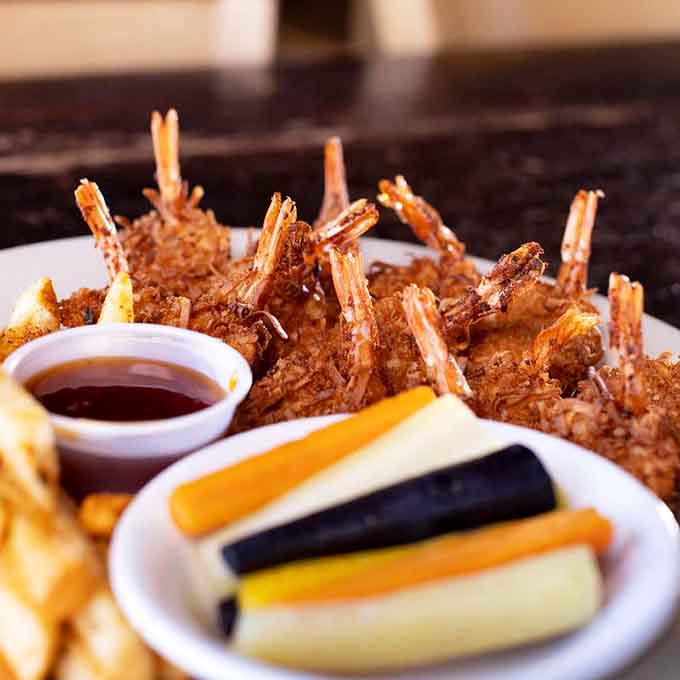 Coconut shrimp that looks like it was breaded by someone who actually cares about your happiness and cholesterol.