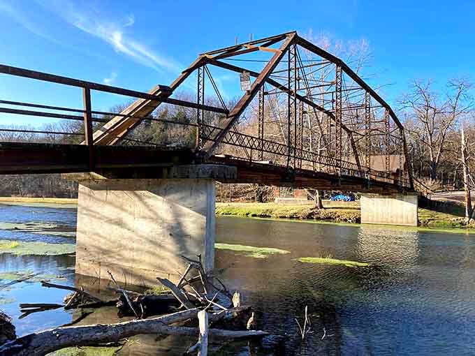 This vintage iron bridge spans the creek with architectural grace that modern engineers study but rarely successfully replicate today.