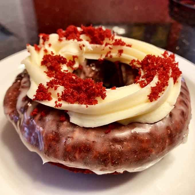 Red velvet cake met a donut and they lived happily ever after in this magnificent cream cheese frosted creation.