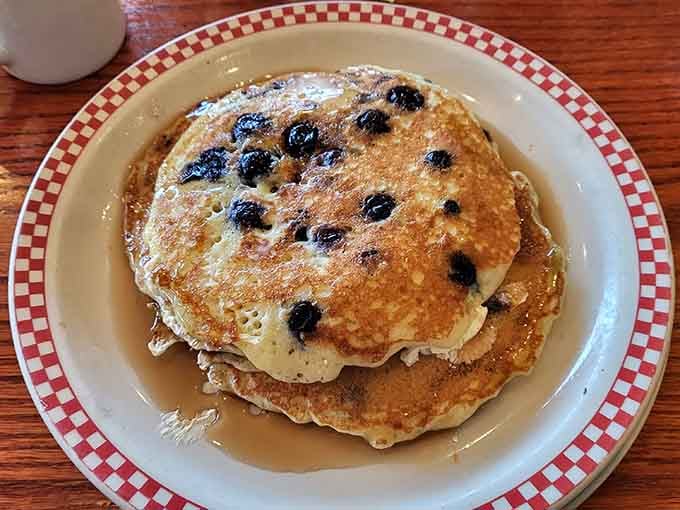 Blueberries studding these pancakes like edible jewels, each bite a sweet reminder that fruit counts as health food, right?