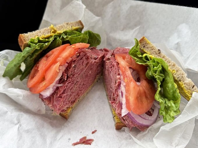 That cross-section reveals layers of perfectly seasoned pastrami that would make a geologist weep with joy.