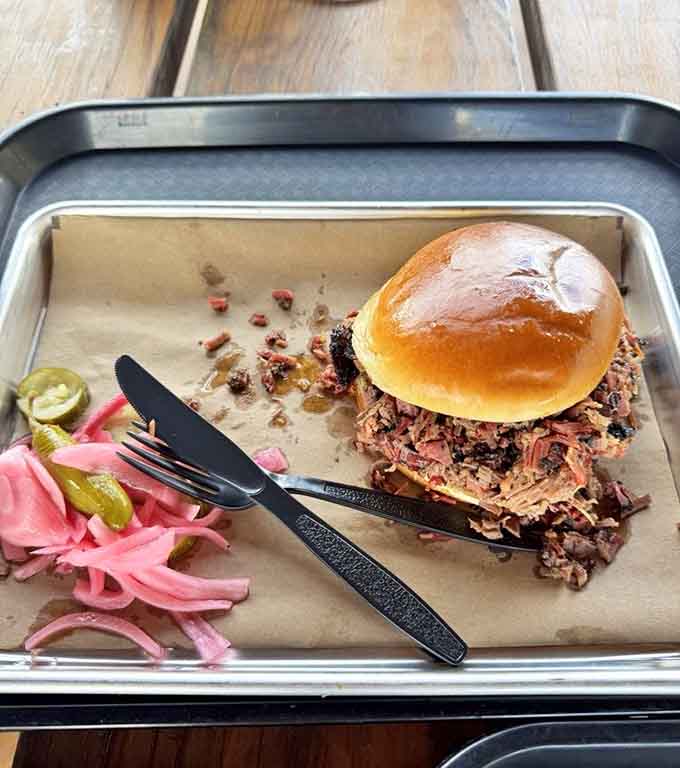 That brisket sandwich is so generously stuffed it makes other sandwiches look like they're on a diet plan.