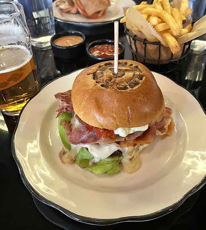 The Queens Rules burger towers like a delicious Jenga game you're about to gleefully destroy with your face.