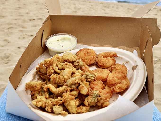 Beach picnic goals achieved: golden fried seafood in a box with tartar sauce, sand between your toes completely optional.