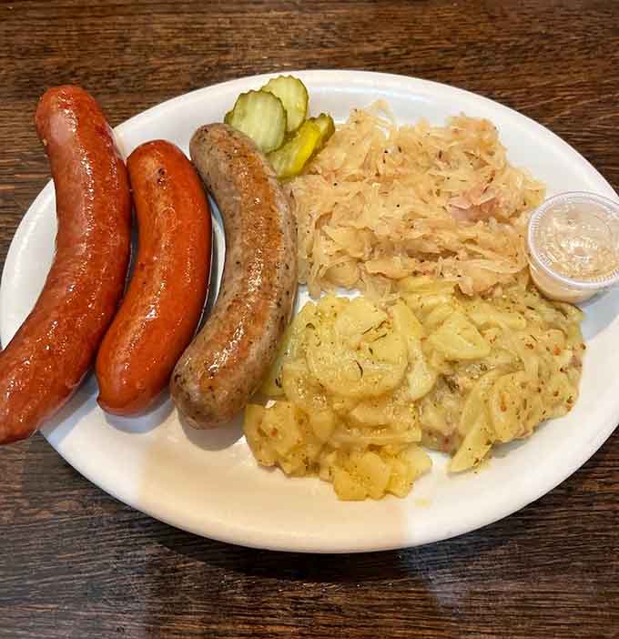 Three sausages walk into a plate with sauerkraut and potato salad, this isn't a joke, it's just Tuesday lunch.