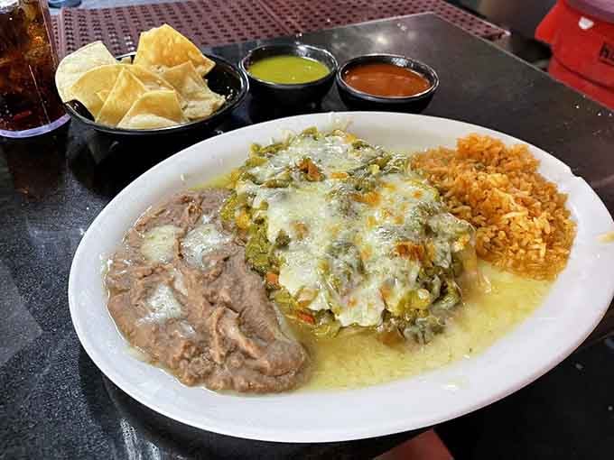 Green chile chicken enchiladas swimming in creamy sauce prove that sometimes the best decisions are the cheesy ones.