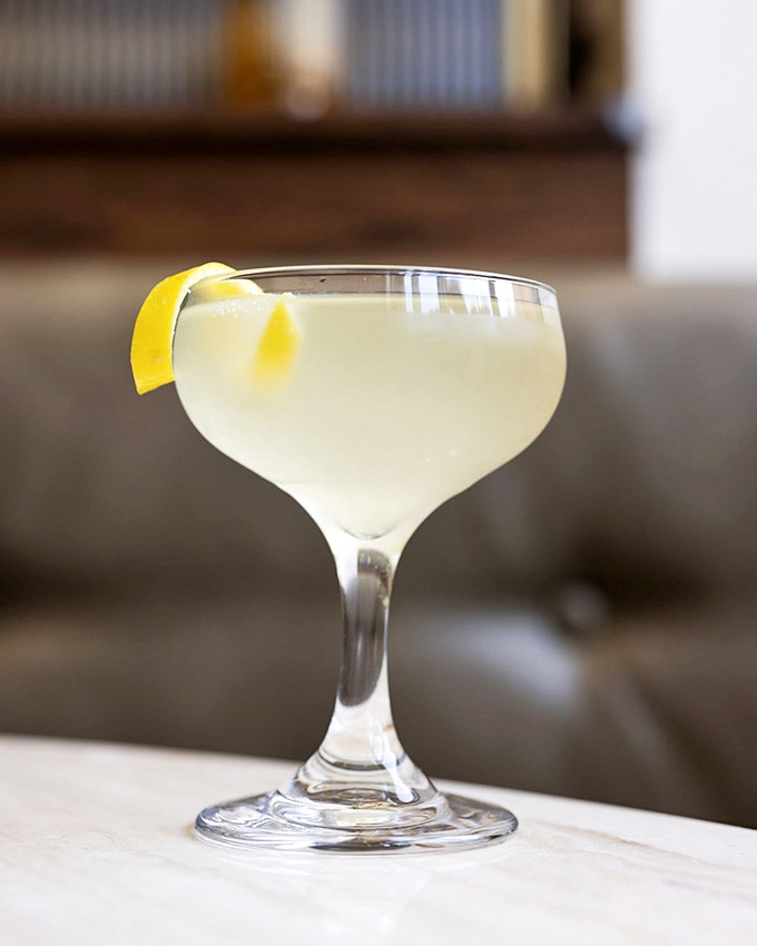 That lemon twist promises refreshment in a coupe glass that belongs in a classic movie scene.