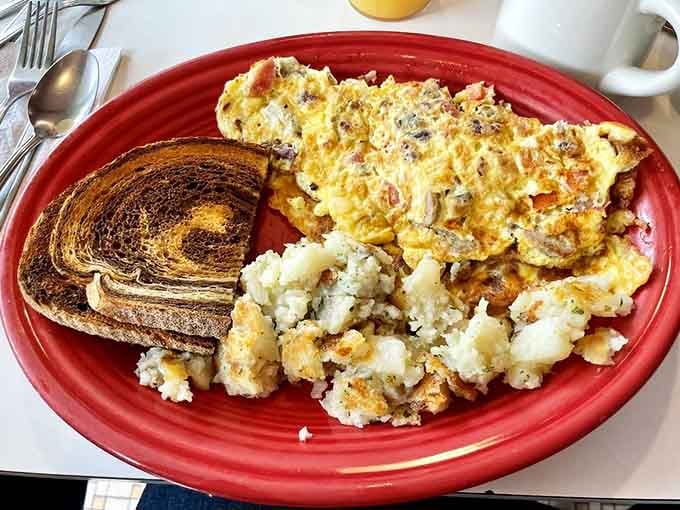 Mediterranean omelet with home fries and rye toast&mdash;breakfast done right on a plate that's seen a thousand happy mornings.
