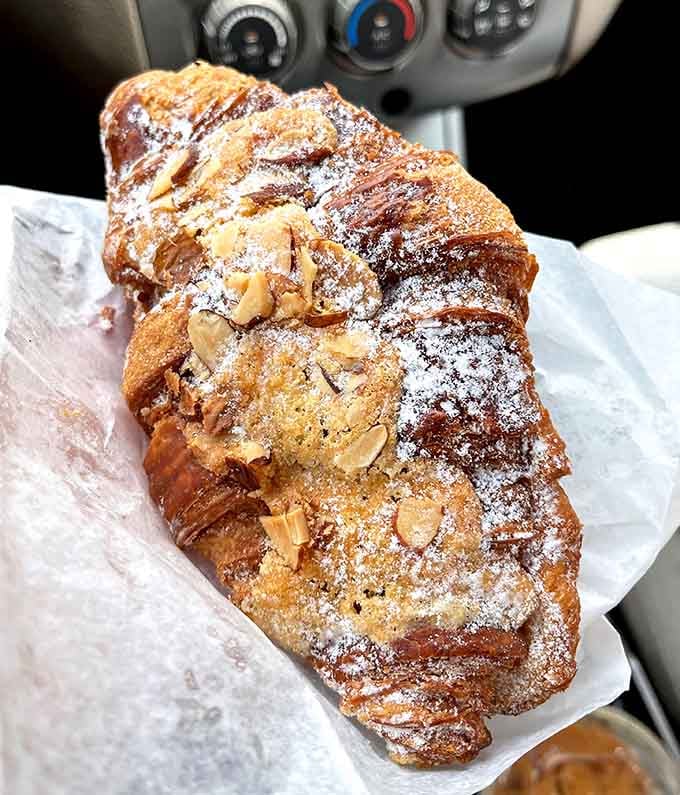 Behold the almond croissant in all its powdered-sugar glory, flaky layers hiding sweet almond cream that'll haunt your dreams.