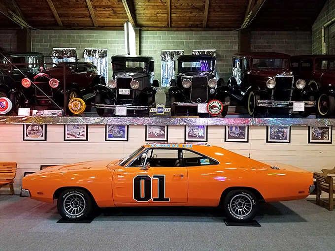 The General Lee himself would approve of this orange muscle car masterpiece parked among vintage Model T's.