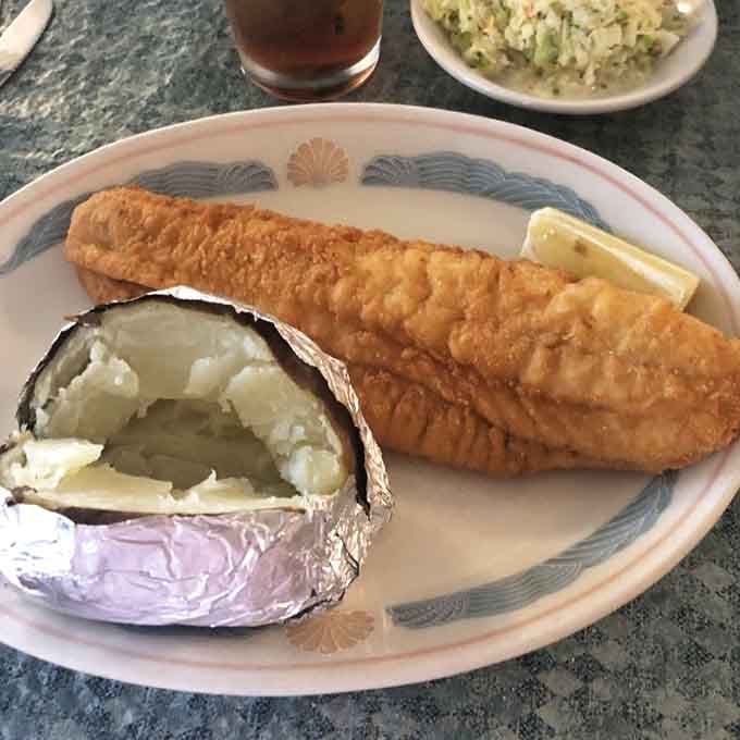 Golden fried flounder with a fluffy baked potato is comfort food elevated to an art form worth celebrating.