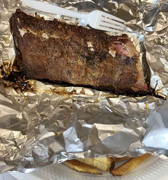 These ribs have that dark, smoky crust that tells you someone back there knows exactly what they're doing.