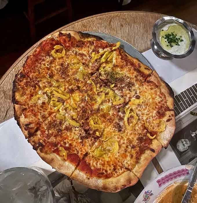 That thin, crispy tavern pie topped with banana peppers and sausage is what happens when pizza goes to finishing school.