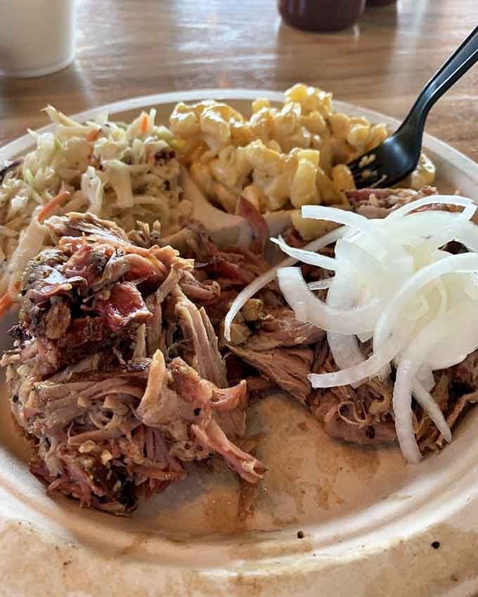 Pulled pork so tender it surrenders without a fight, piled high like edible treasure on butcher paper.