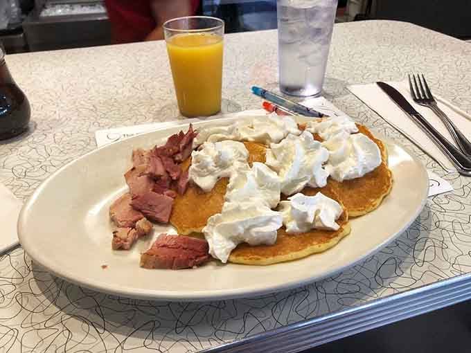 Silver dollar pancakes topped with whipped cream prove good things really do come in small, perfect packages.