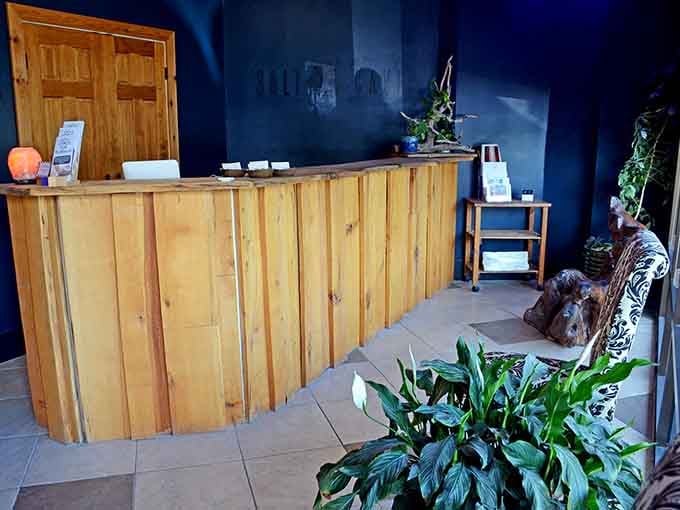 This wooden reception desk radiates natural warmth, setting the tone for the peaceful experience that lies just beyond.