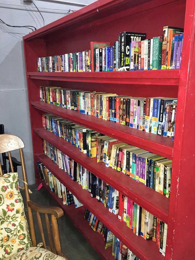A bright red bookshelf packed with stories, because every good book deserves a second reader and third adventure.