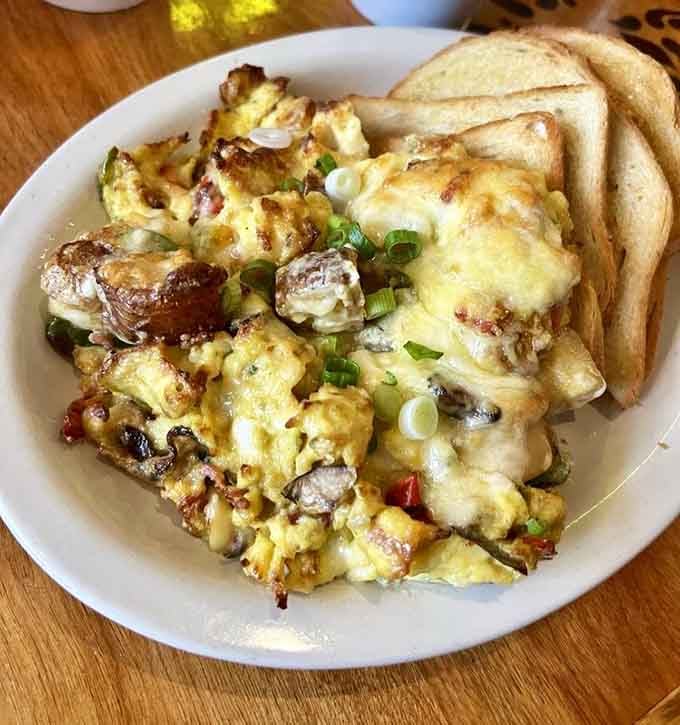 That golden scramble with melted cheese is what happens when eggs reach their full potential and then some.