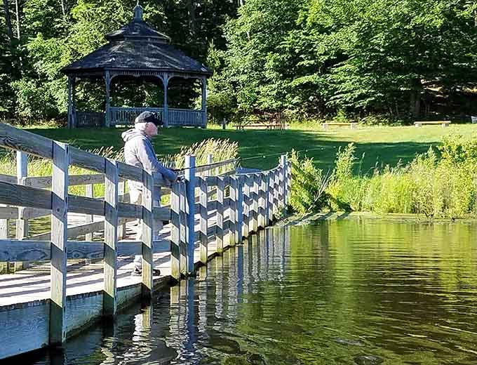 Fishing from a wooden dock with a gazebo backdrop beats any corporate team-building exercise ever invented by consultants.