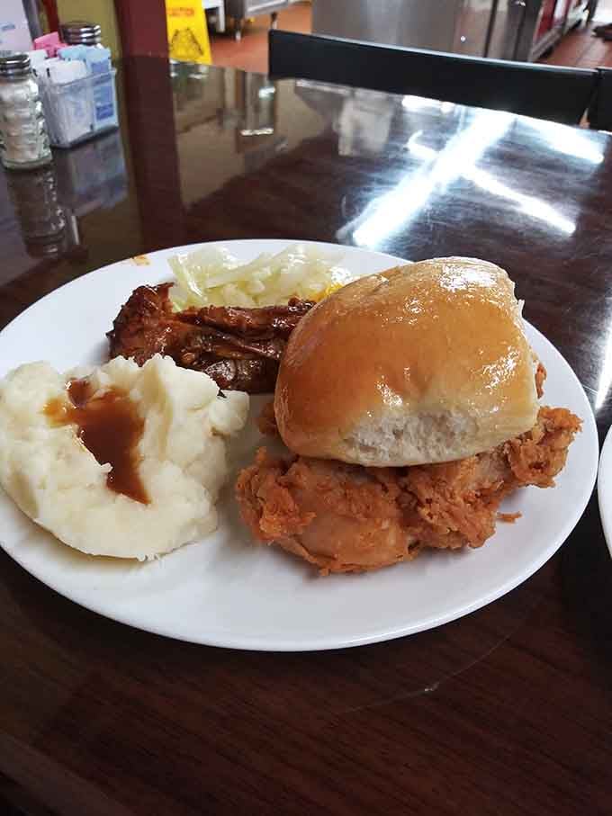 Fried chicken on a roll with mashed potatoes swimming in gravy is basically a hug on a plate.