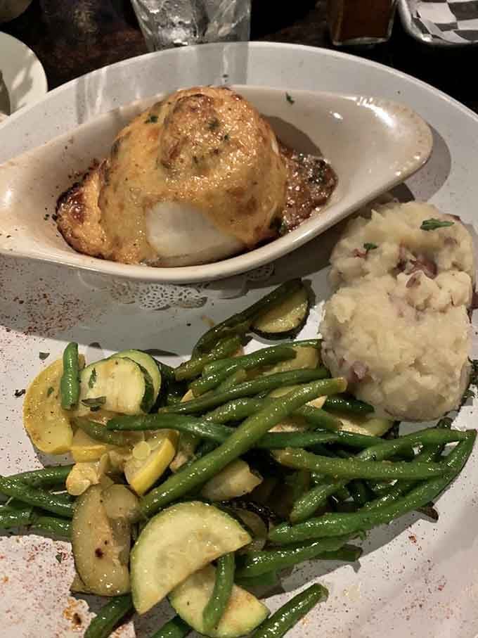 That stuffed flounder sits like a crown jewel, surrounded by fresh vegetables that actually look appetizing for once.