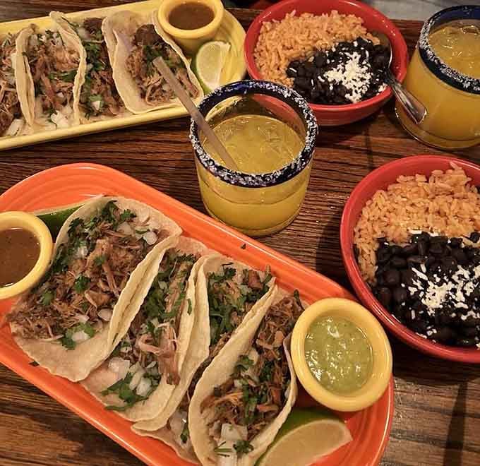 Carnitas tacos so tender they practically apologize for being this delicious on a Tuesday afternoon.