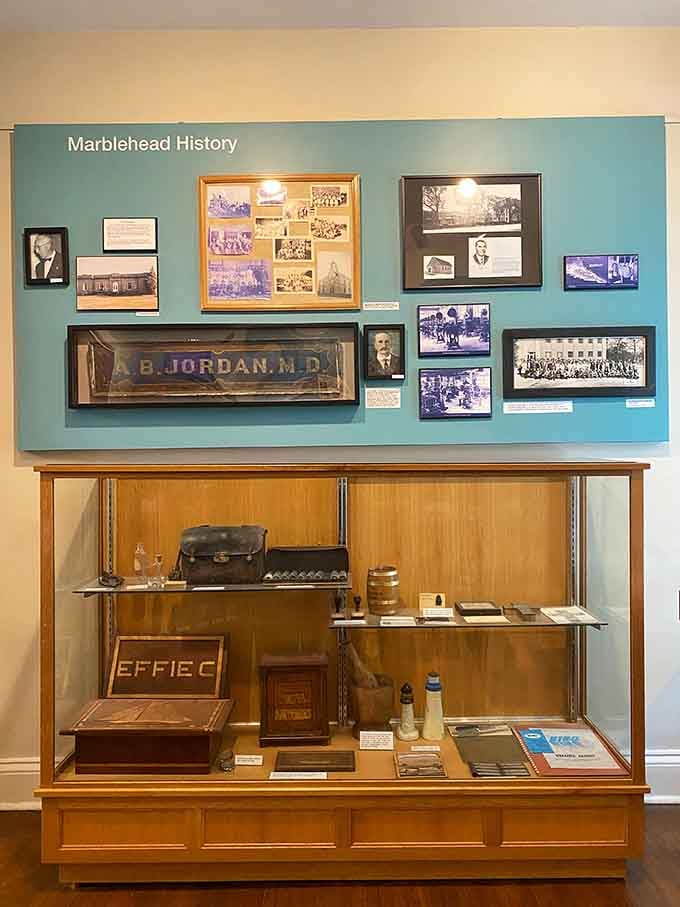 Local history fills these display cases, from old medical bags to community photographs spanning generations of lakeside living.
