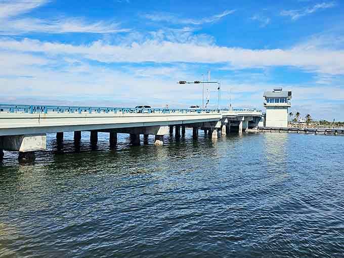 The bridge stretches across glassy waters like a gateway to somewhere time forgot to rush through.
