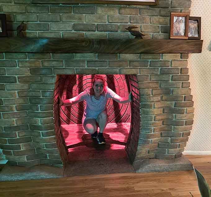 That fireplace isn't just decorative, it's your rabbit hole into dimensions where living rooms have serious identity crises.