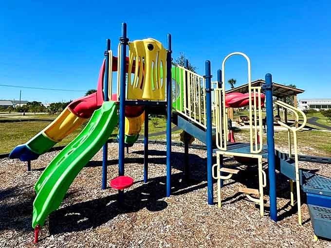 Primary colors pop against blue sky at a park that remembers childhood should involve actual playing outside.