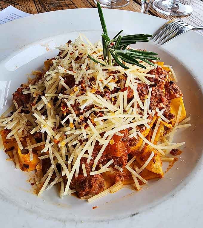 Pasta topped with enough cheese to make your cardiologist nervous and your taste buds throw a parade of joy.