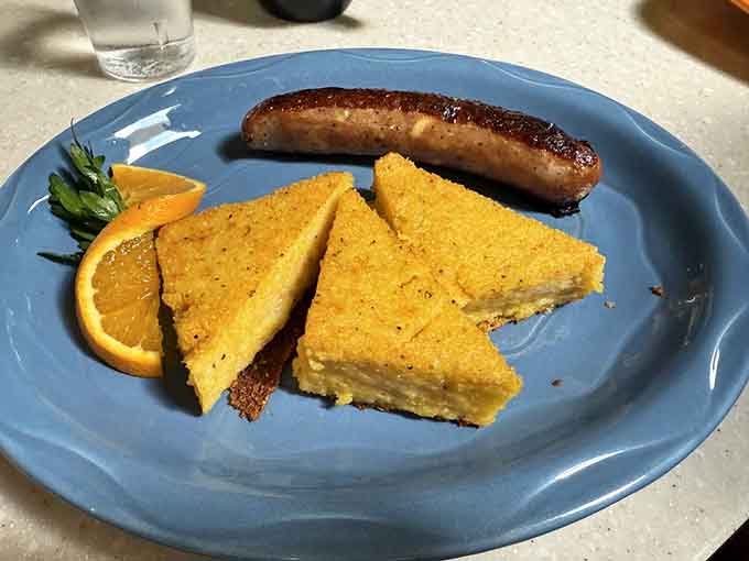 Golden crispy polenta triangles paired with perfectly cooked sausage create a symphony of morning flavors.