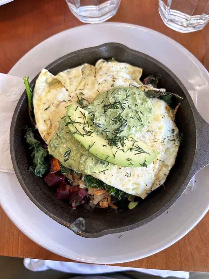 The Greenhouse Skillet arrives looking like someone put a vegetable garden on top of perfectly cooked eggs and hash.