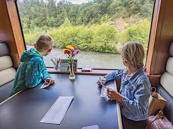 Two young artists capture the passing scenery, proving that sometimes the best entertainment doesn't require a screen or WiFi.