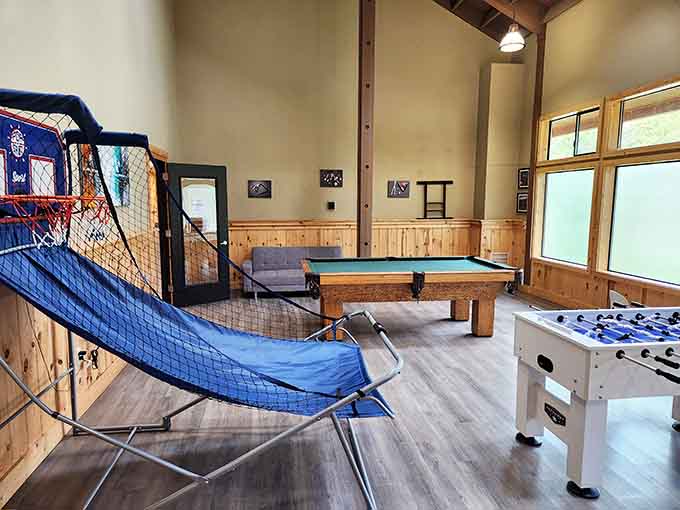The game room features pool tables, foosball, and basketball because sometimes nature needs a timeout for friendly competition indoors.