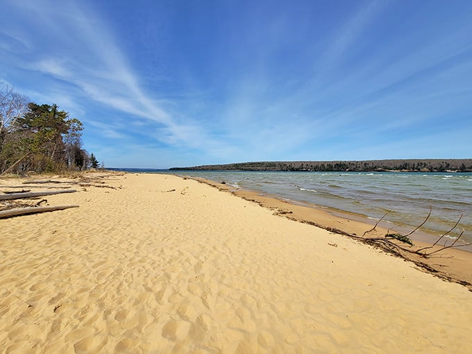 Sand Point Beach stretches empty and golden, waiting for you instead of a thousand Instagram influencers.