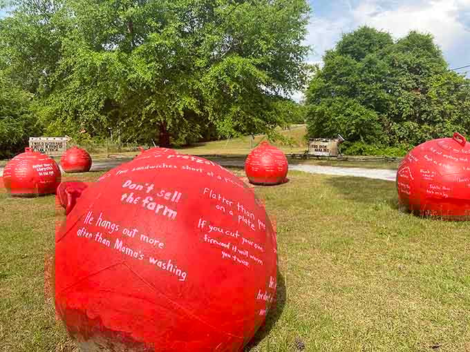 These bright red spheres scattered across the lawn look like giant fortune cookies sharing philosophical wisdom with passersby.
