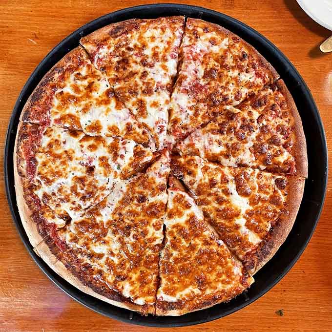 That golden, bubbly cheese stretched across crispy crust is what pizza dreams are made of, plain and simple.