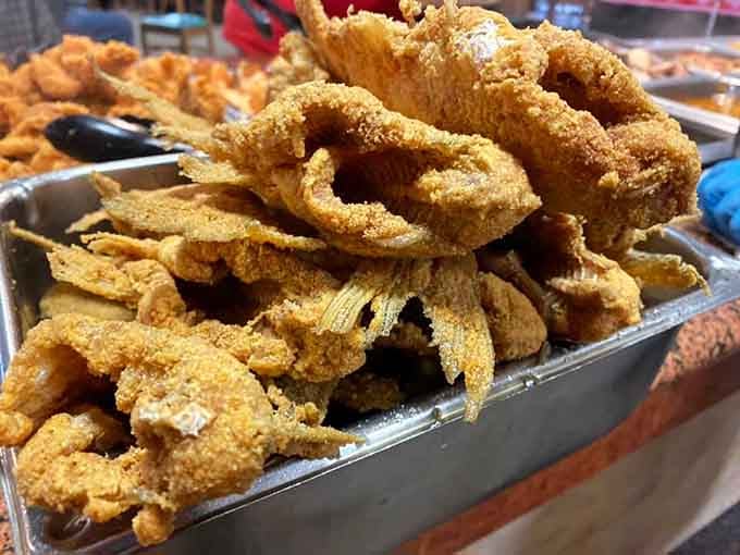 Mountains of perfectly fried catfish waiting to make your day infinitely better, one crispy piece at a time.