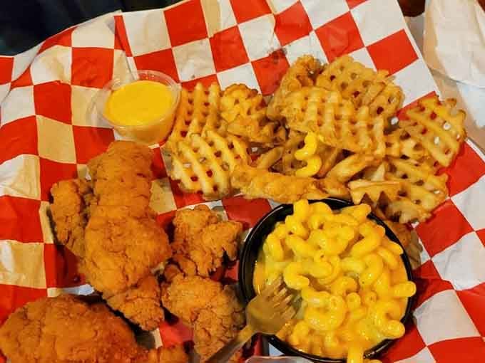 Golden fried chicken, creamy mac and cheese, and waffle fries form the holy trinity of comfort food.