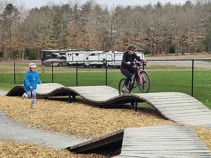 Kids mastering balance beams while parents master the art of relaxing nearby; everyone wins at this setup.