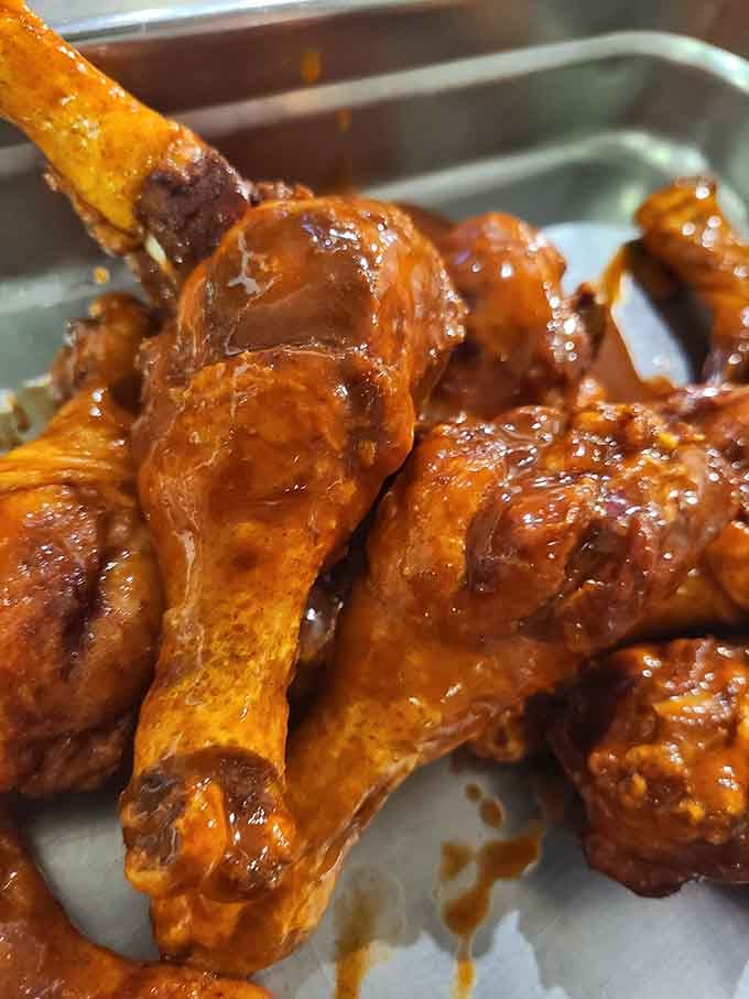 These glazed wings glisten like edible treasure, sticky and magnificent in all their finger-licking glory.