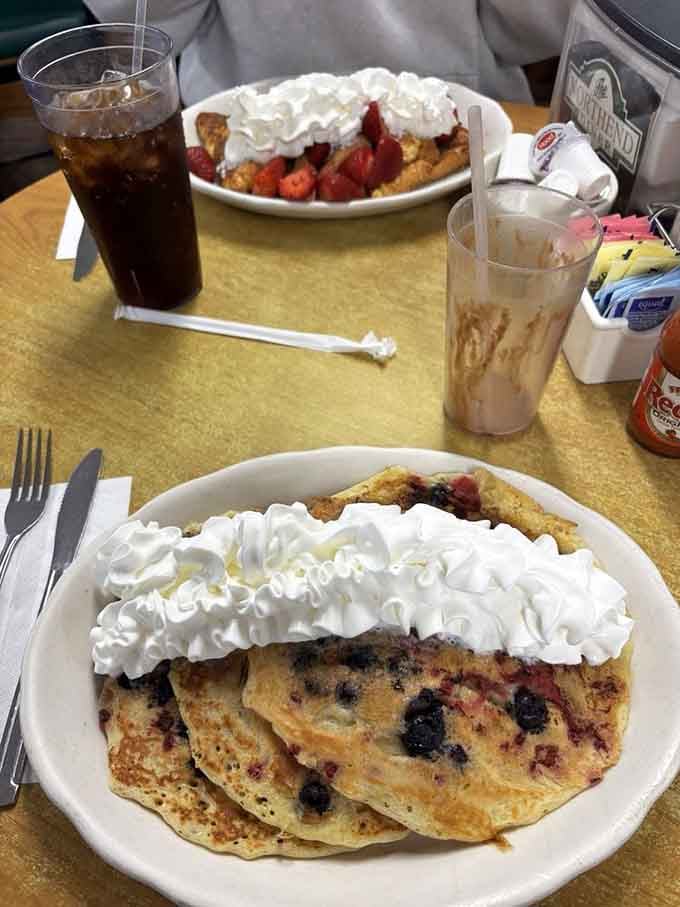 Berry-studded pancakes crowned with whipped cream mountains that would make dessert jealous of breakfast's glory.