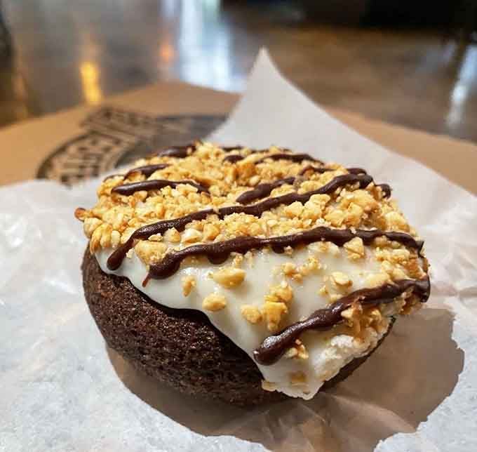 This chocolate creation topped with peanut butter crumbles proves vegan donuts can absolutely steal the show.