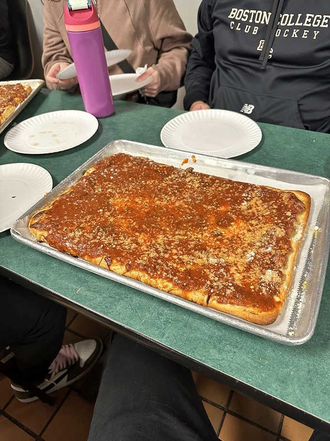The rectangular Sicilian pie arrives like a delicious geometry lesson, proving that sometimes the best things come in unexpected shapes.