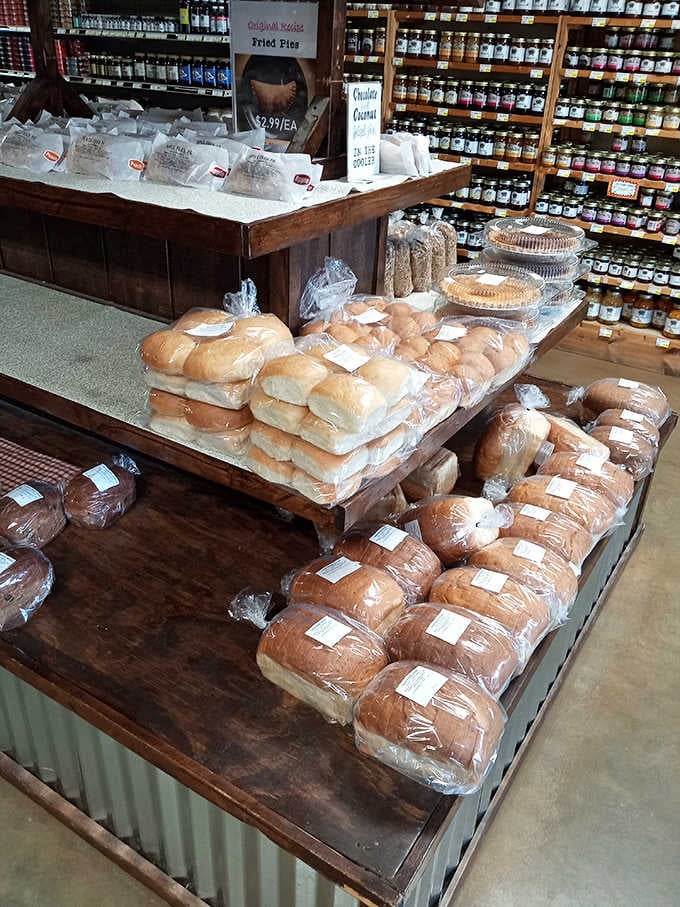 Rustic wooden displays showcase loaves stacked like edible treasure, with jams lining the walls like sweet soldiers.