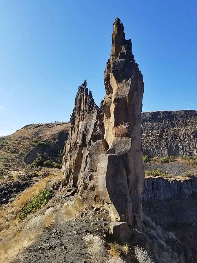 These towering rock formations stand like ancient sentinels, reminders of volcanic fury that shaped this dramatic landscape.