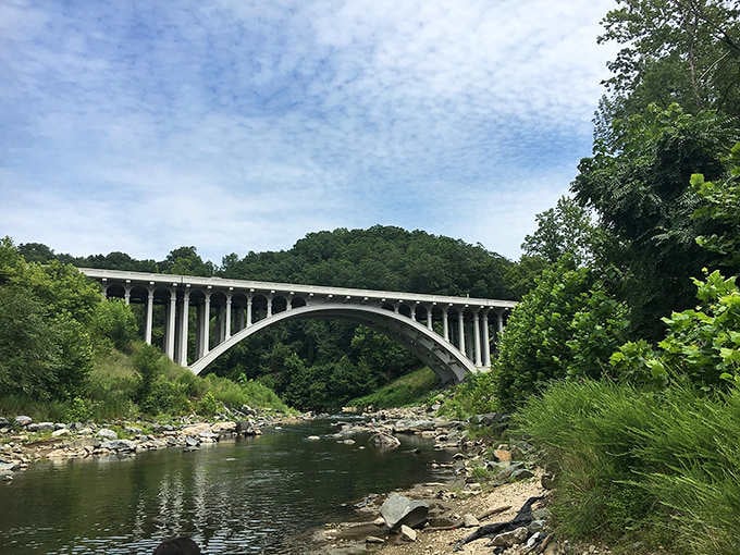 Engineering meets wilderness under this graceful arch, creating a view that cameras never quite capture properly.