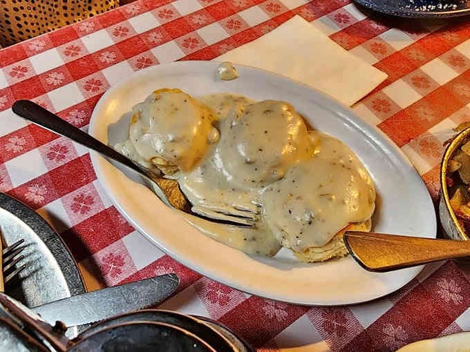 Biscuits drowning in peppery gravy—this is comfort food that actually earns the title.